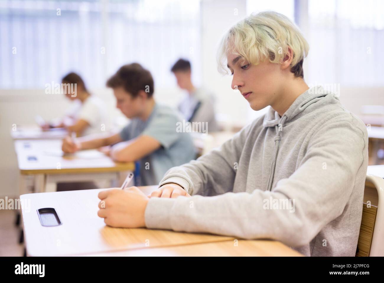 Contemporary schoolboy sitting desk hi-res stock photography and images ...