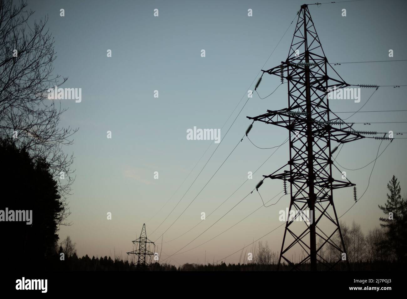 Power lines in evening. Tower of electricity against sky. Steel ...