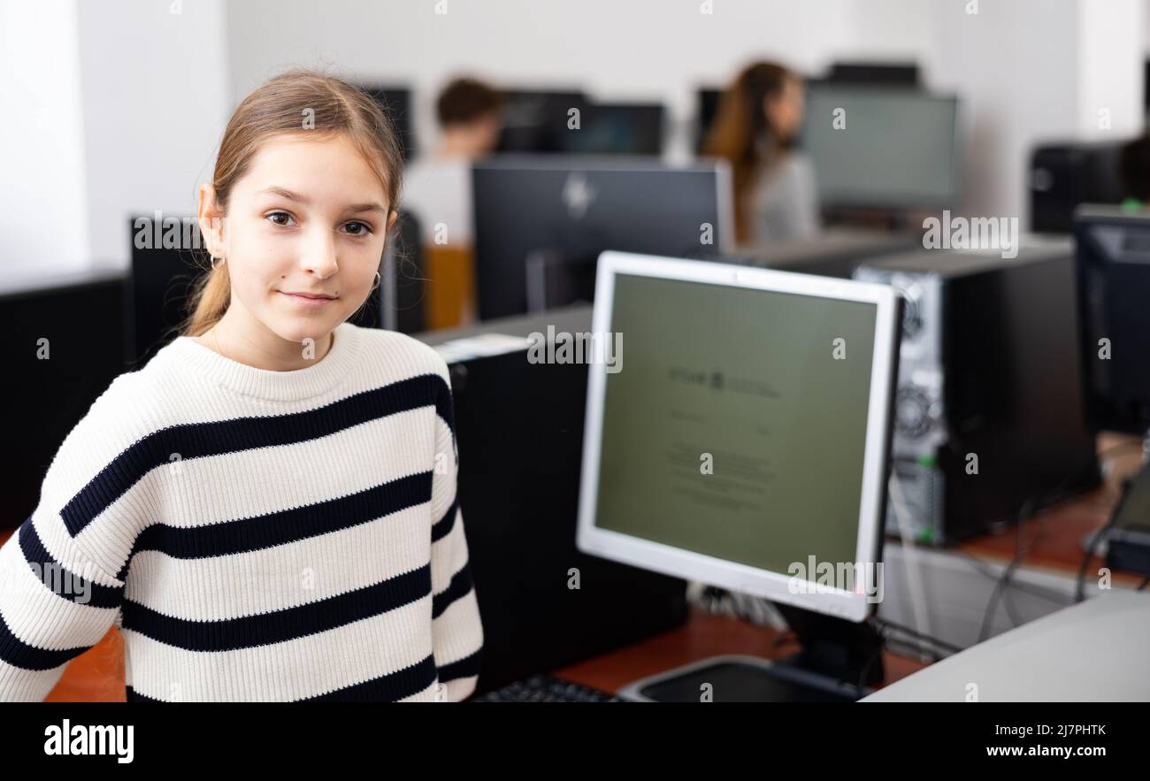 Portrait of young girl in computer class Stock Photo - Alamy