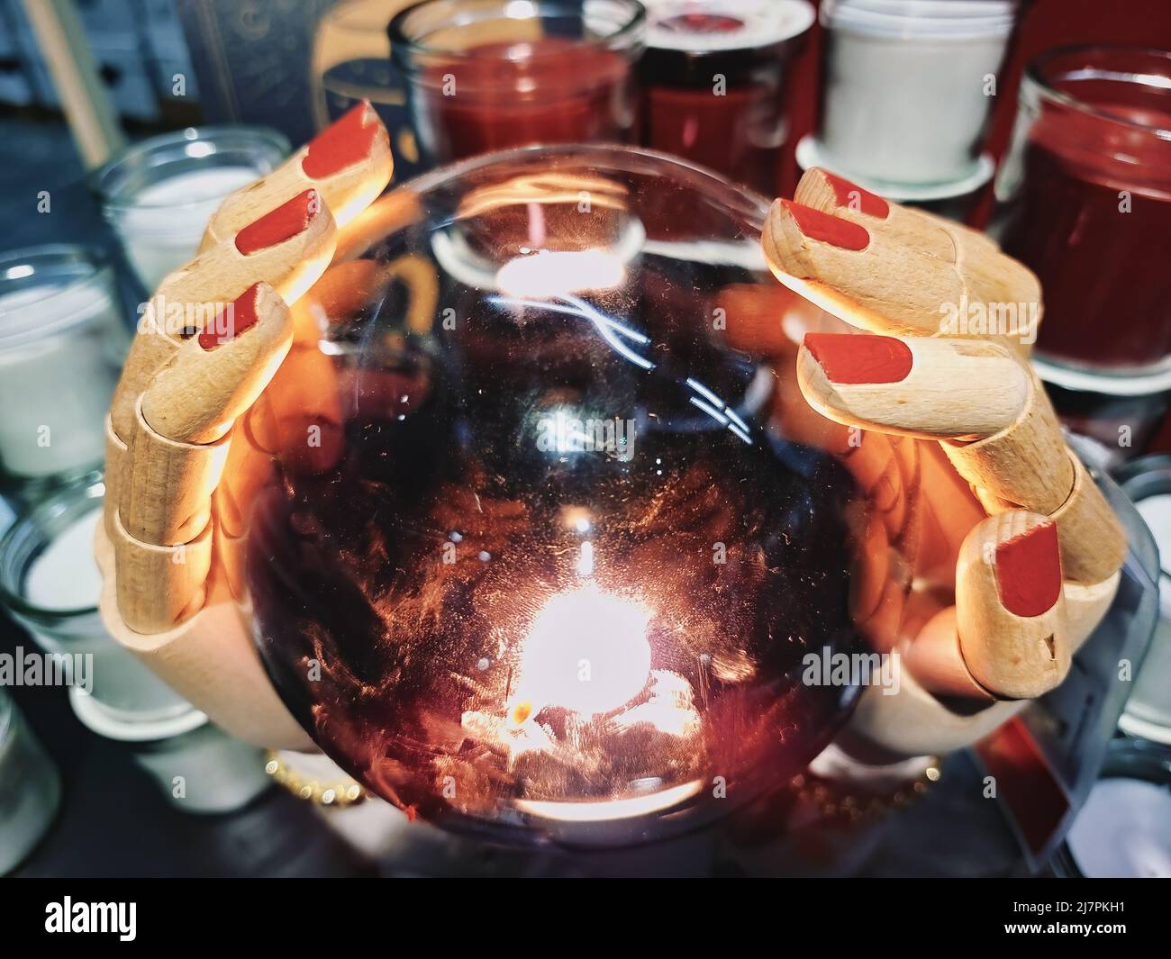 Wooden hands on a magic crystal ball to guess the future. Concept of ...