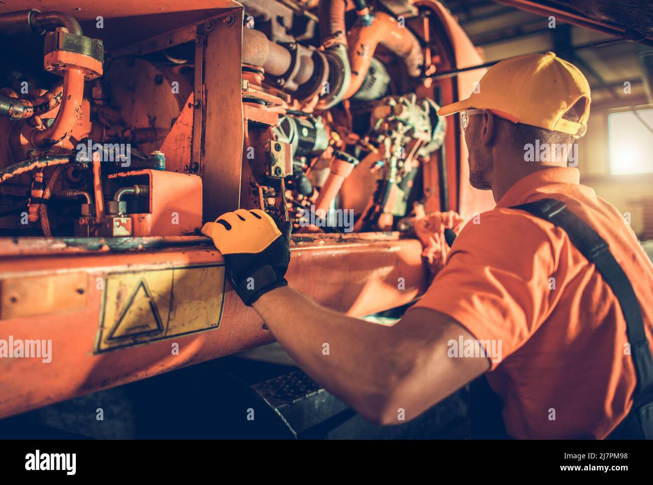 Caucasian Heavy Construction Equipment Mechanic in His 40s Repairing ...