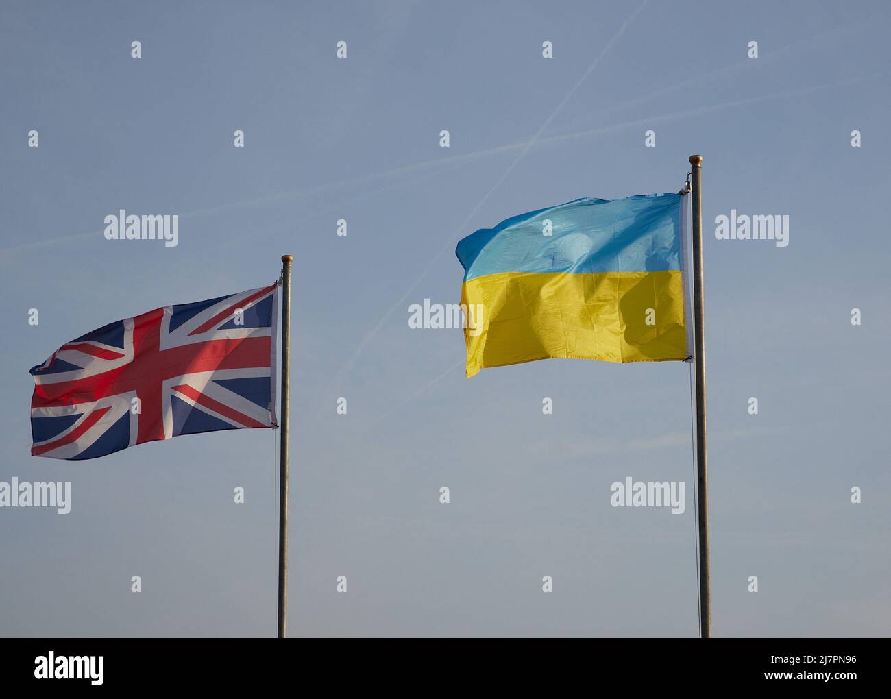 UK and Ukrainian flags seen flying side by side on flagpoles side by ...