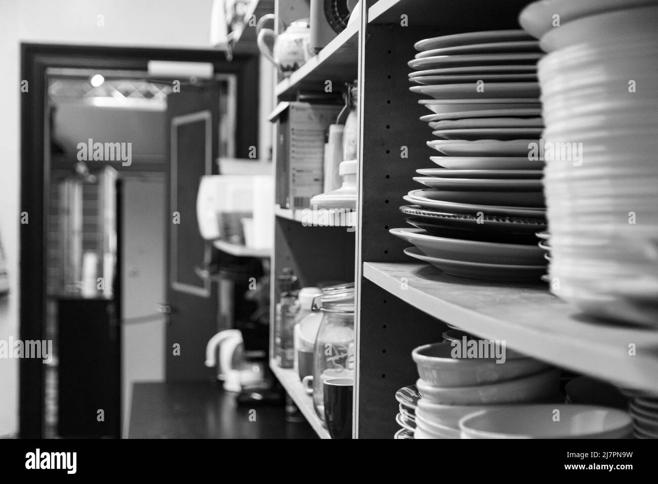 Clean dishes stacked in a kitchen service area Stock Photo - Alamy
