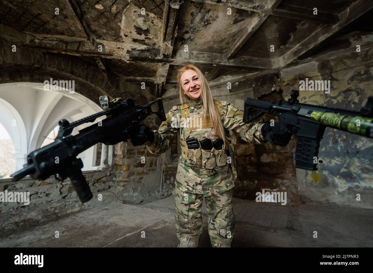 Girl holding guns hi-res stock photography and images - Alamy