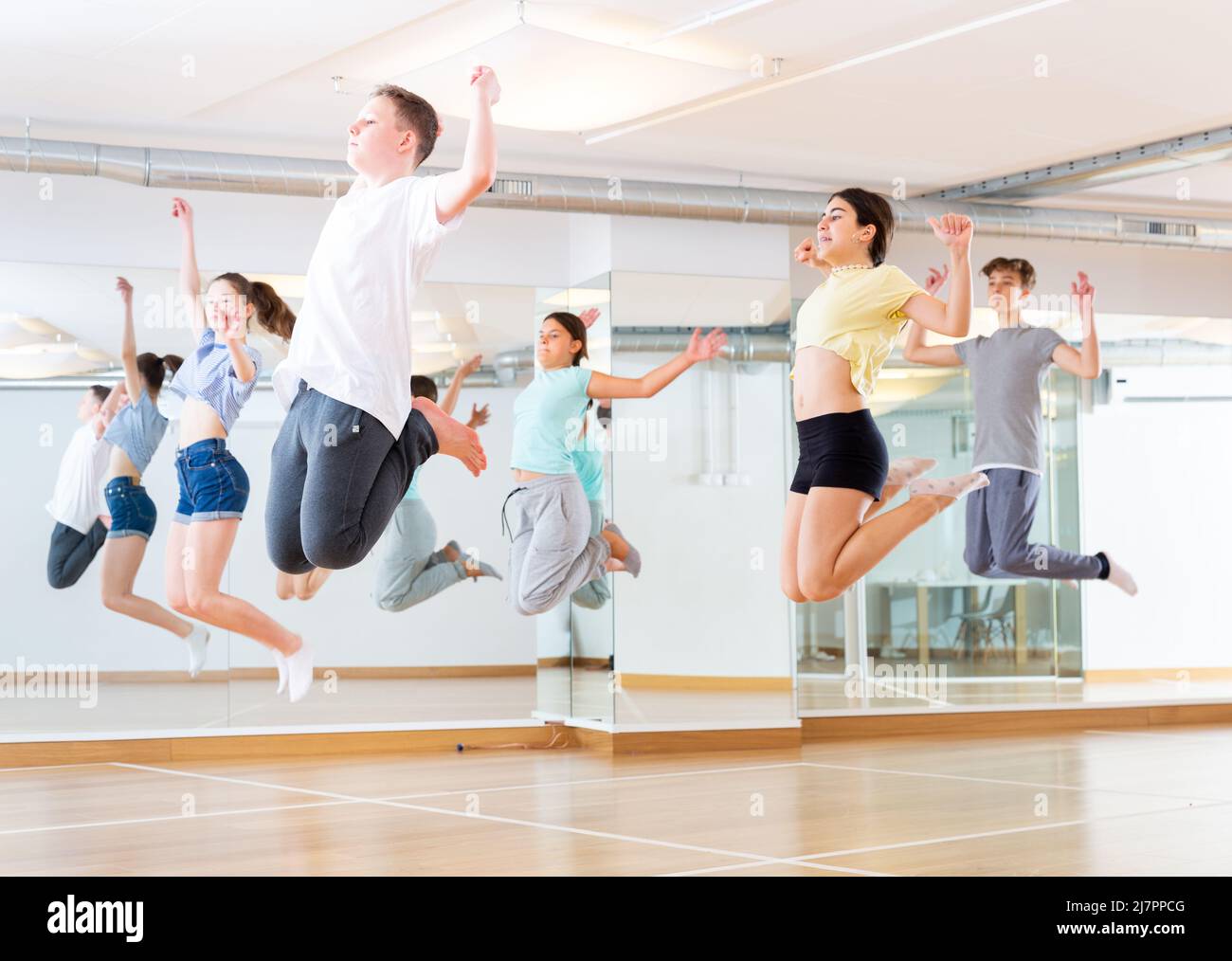 Group of teenagers jumping during dance workout Stock Photo - Alamy