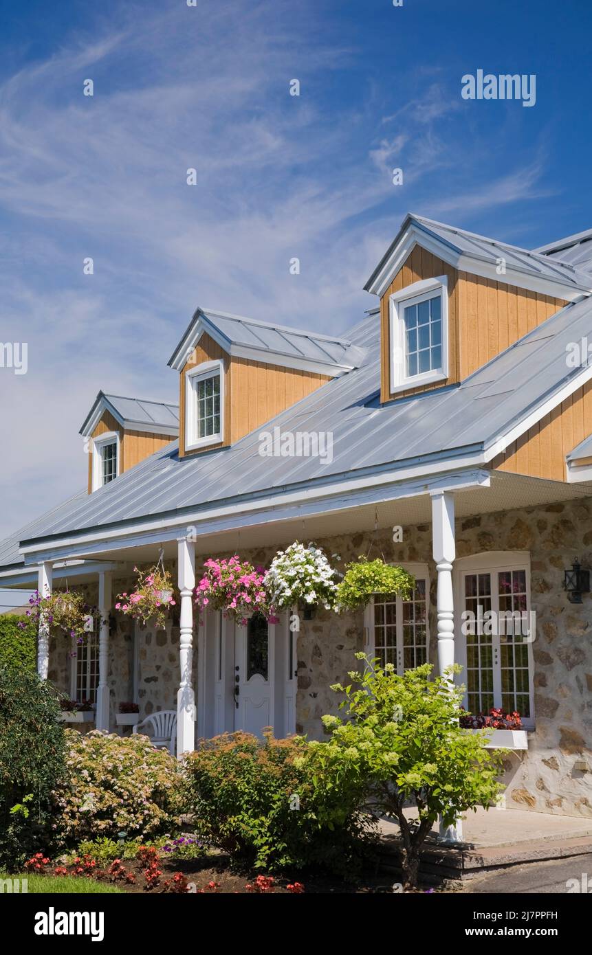 Replica of old 1800s Canadiana cottage style fieldstone home with white ...