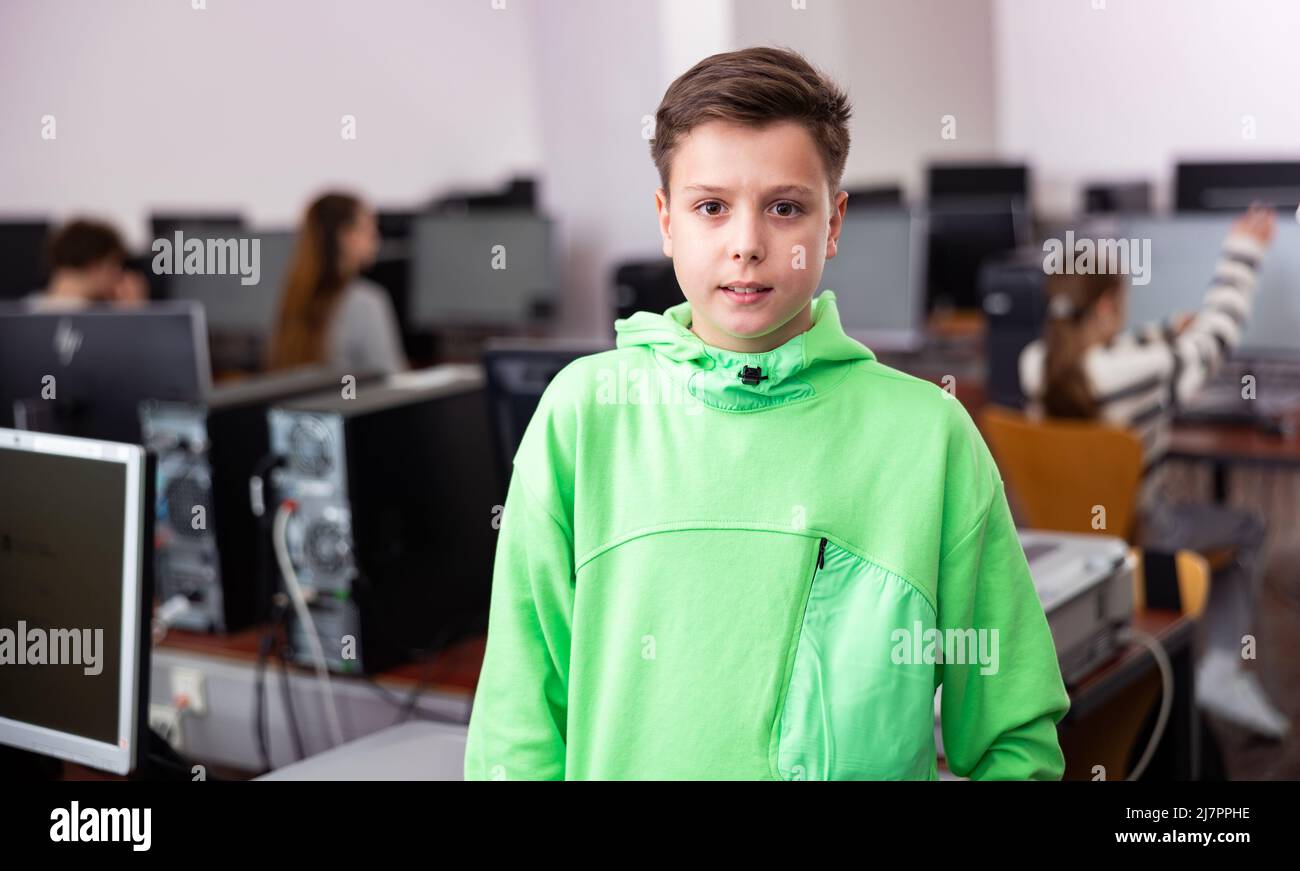 Teenager boy standing in computer class Stock Photo - Alamy