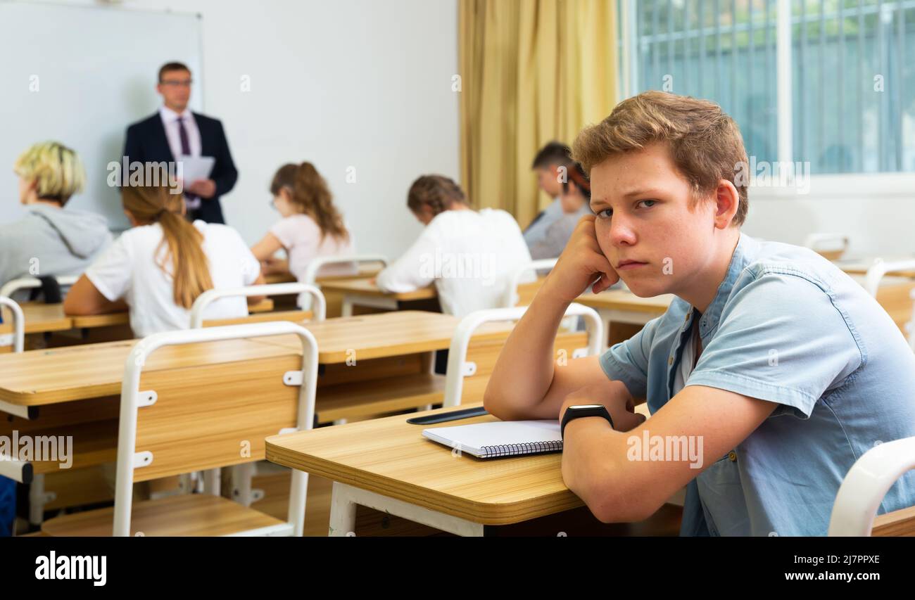 Portrait of tired student in school class Stock Photo - Alamy