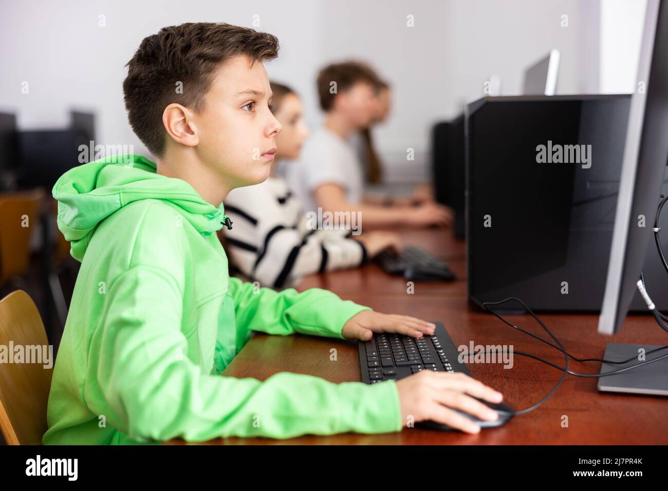 Schoolboy using PC during computer science lesson Stock Photo - Alamy
