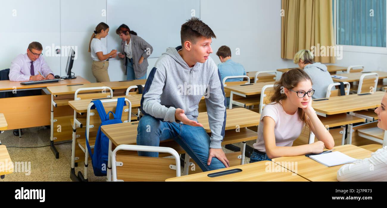 Teenage students talking during recess between lessons Stock Photo - Alamy