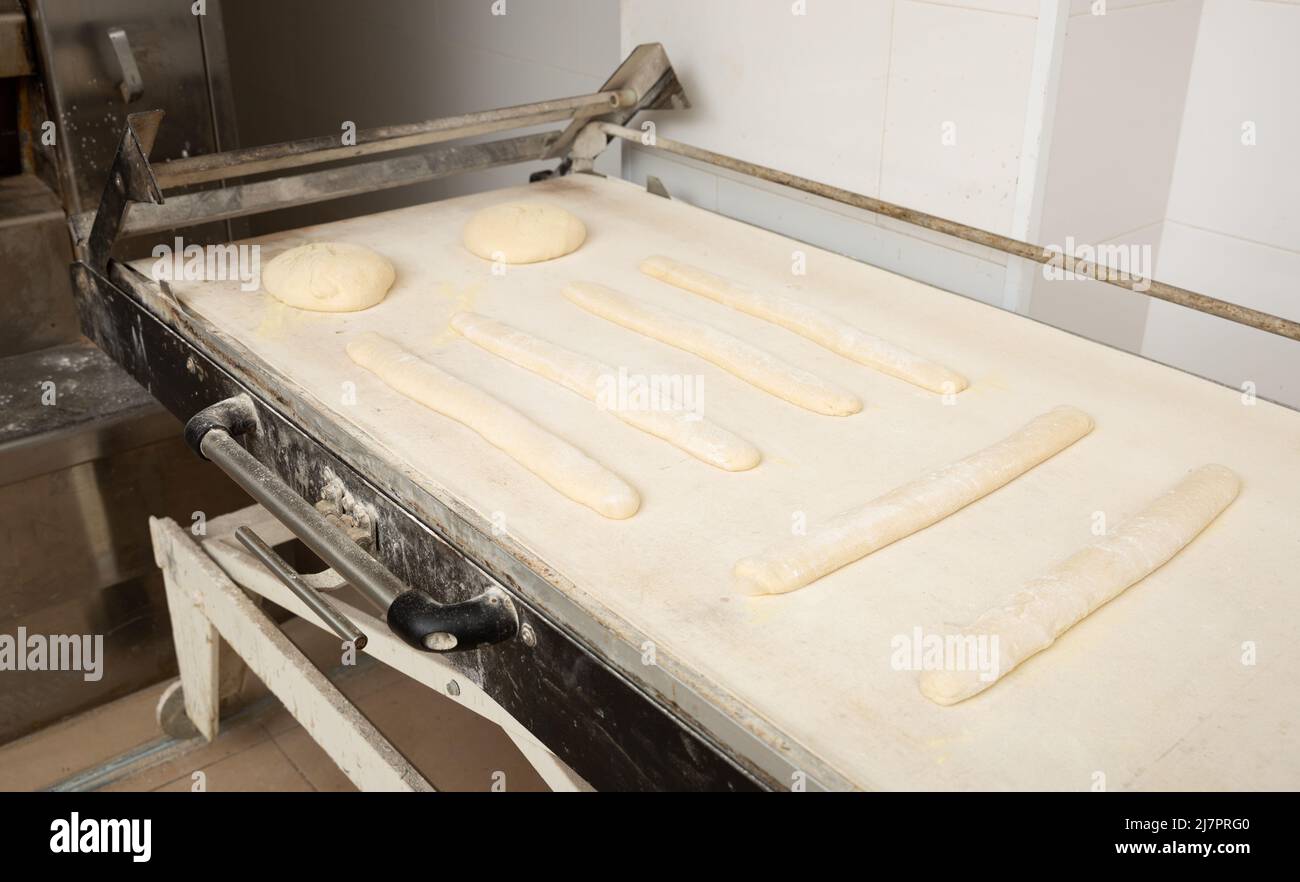 Proofing bread and baguettes in baker workshop Stock Photo - Alamy