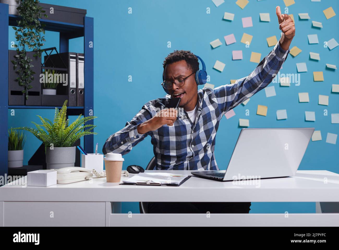 Excited cheerful african american office worker wearing wireless ...
