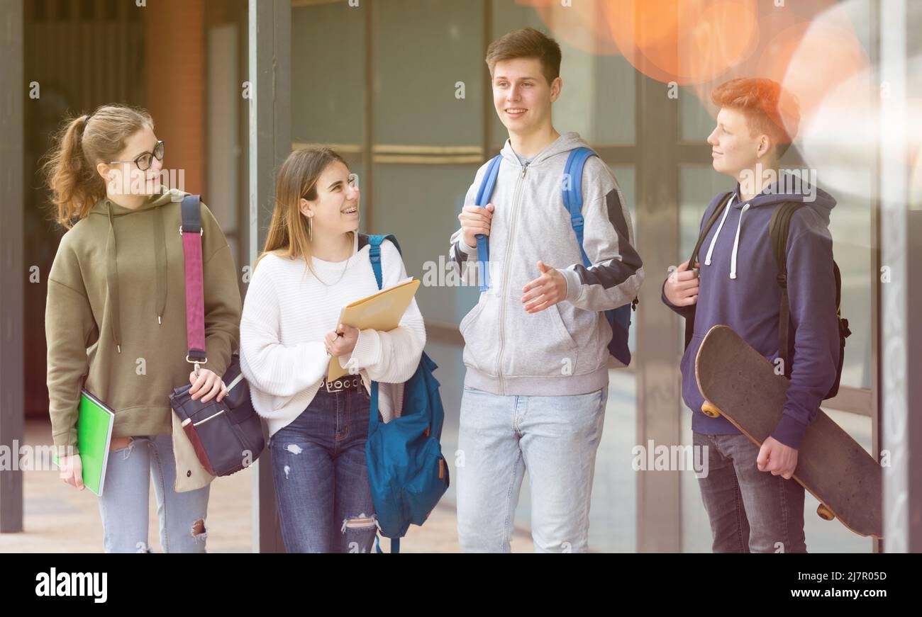 Carefree teen students walking outside school Stock Photo - Alamy