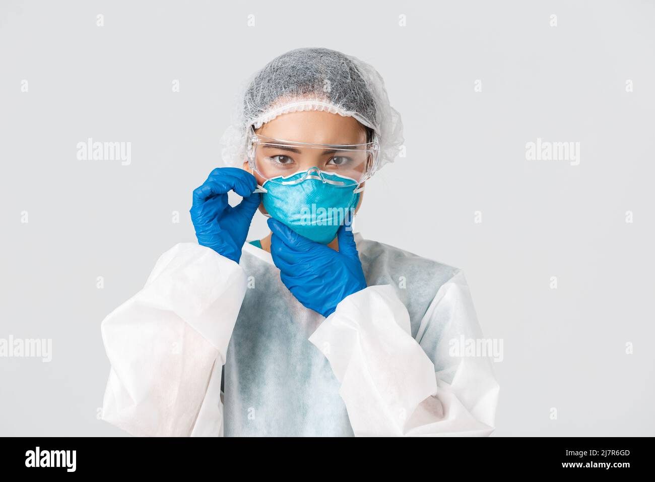 Covid-19, coronavirus disease, healthcare workers concept. Serious asian female doctor prepare ...