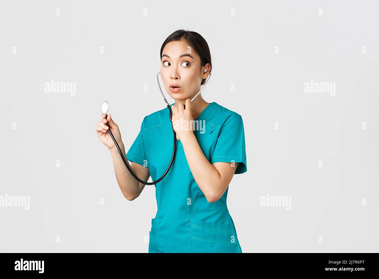 Covid-19, healthcare workers and preventing virus concept. Intrigued ...