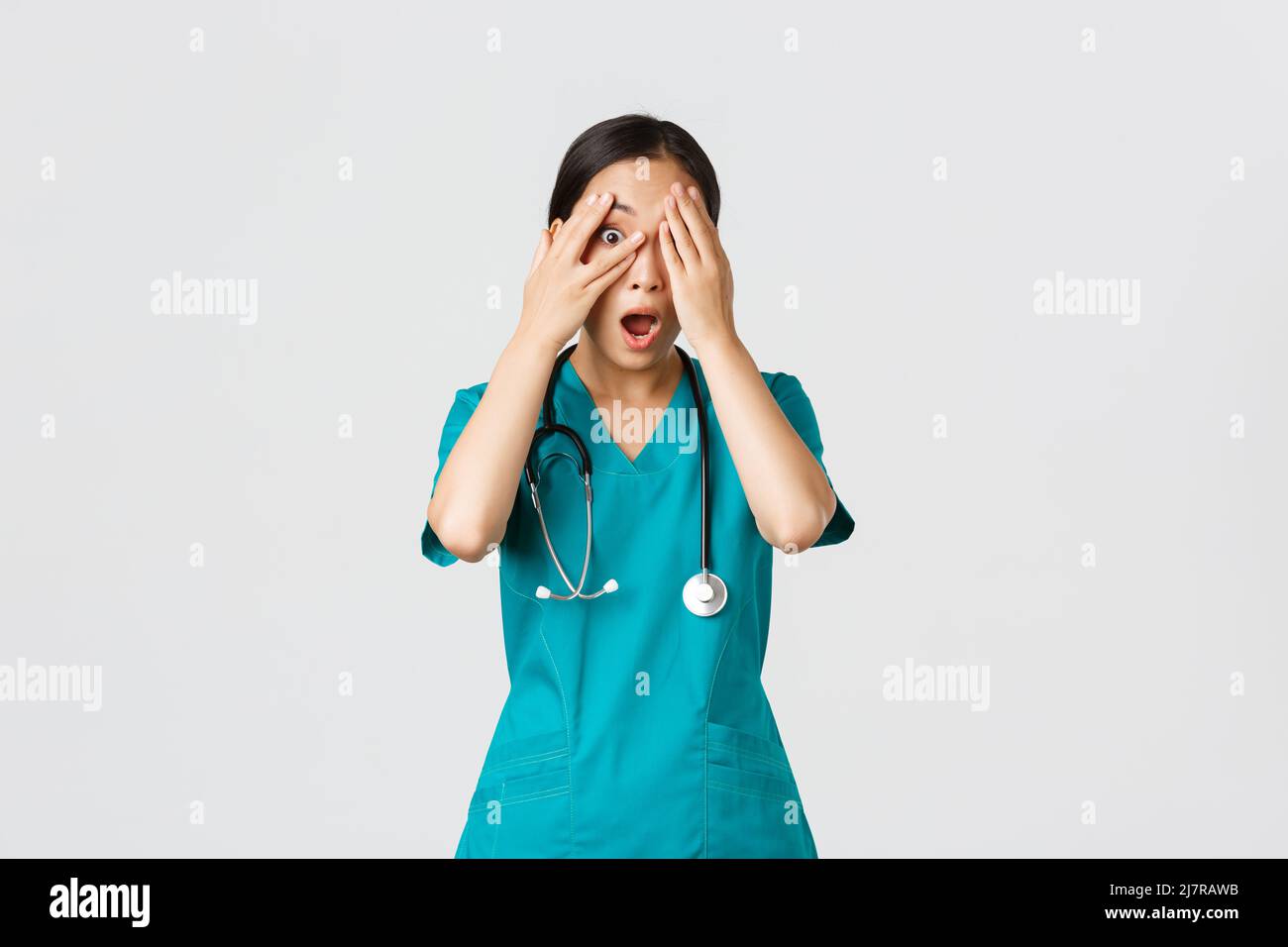 Covid-19, healthcare workers and preventing virus concept. Scared and ...