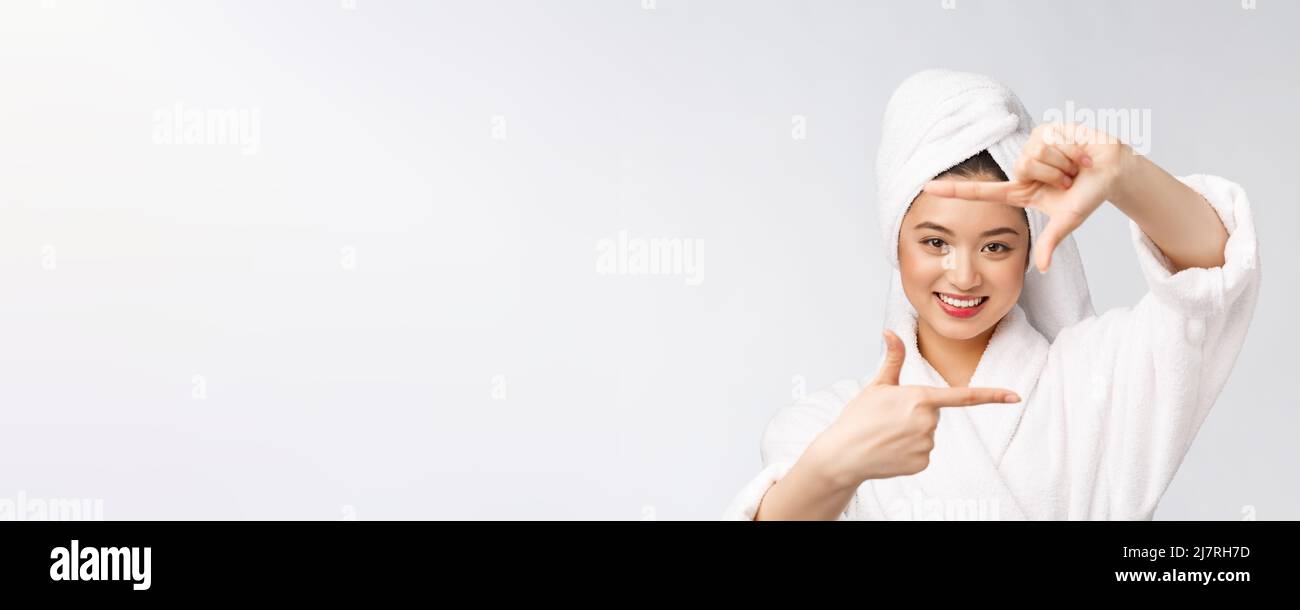 Beautiful Woman face and she making frame with hands with health skin ...