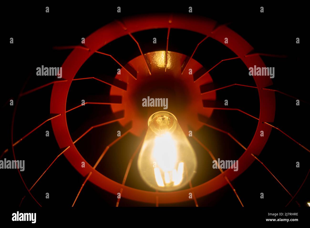 Lamp in dark. Incandescent lamp shines yellow. Details of design of ...