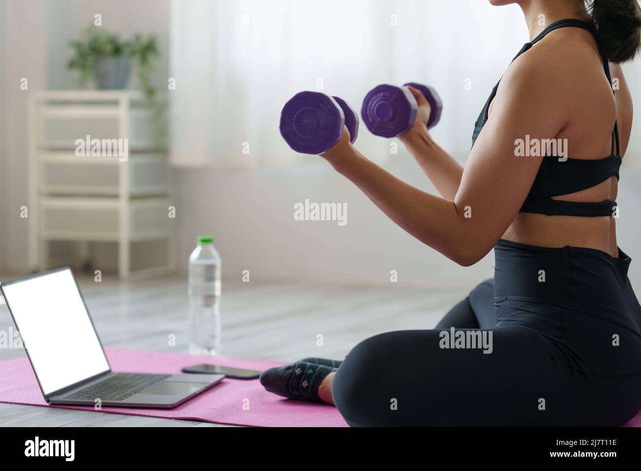 Beautiful woman exercising with dumbbells at home. bodybuilding ...