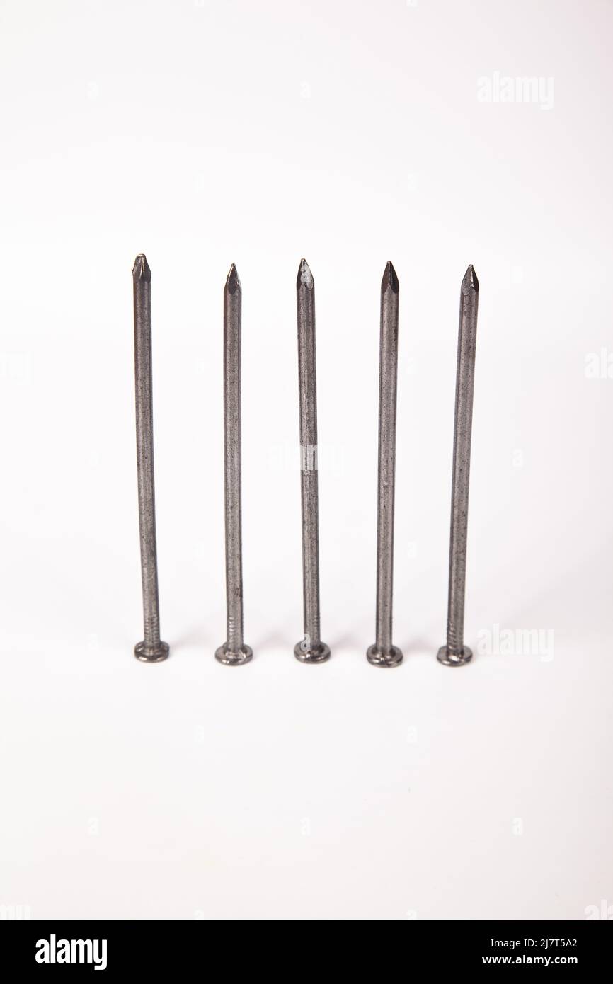 A lot of construction iron nails, industrial parts, isolated on white ...