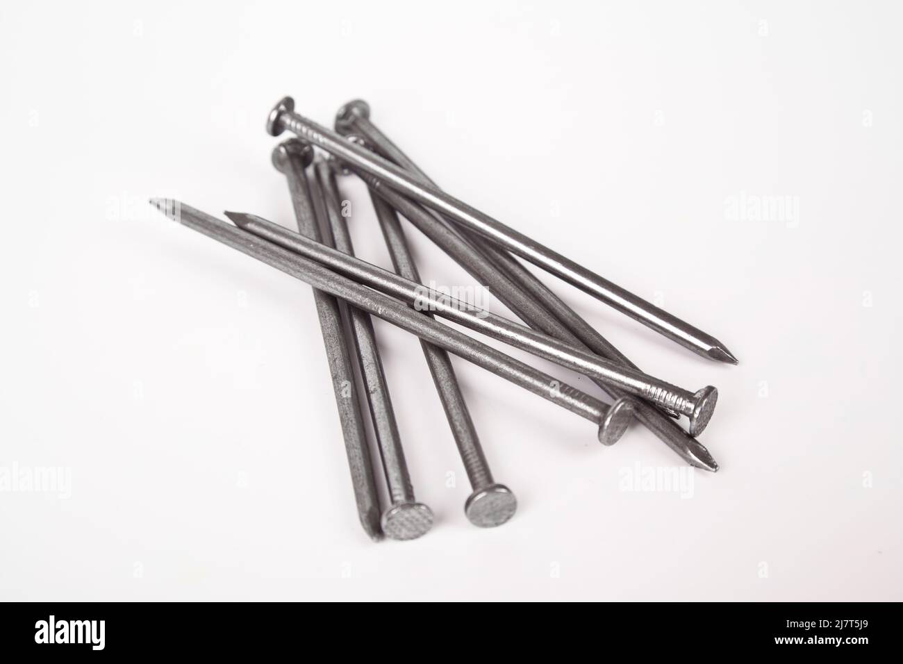 A lot of construction iron nails, industrial parts, isolated on white ...