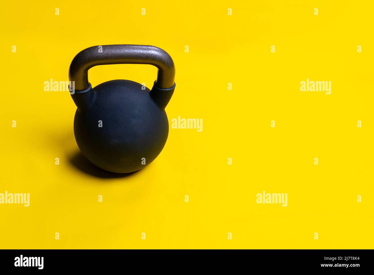 Black space isolated yellow kettlebell ackground fitness cast dumbbell ...