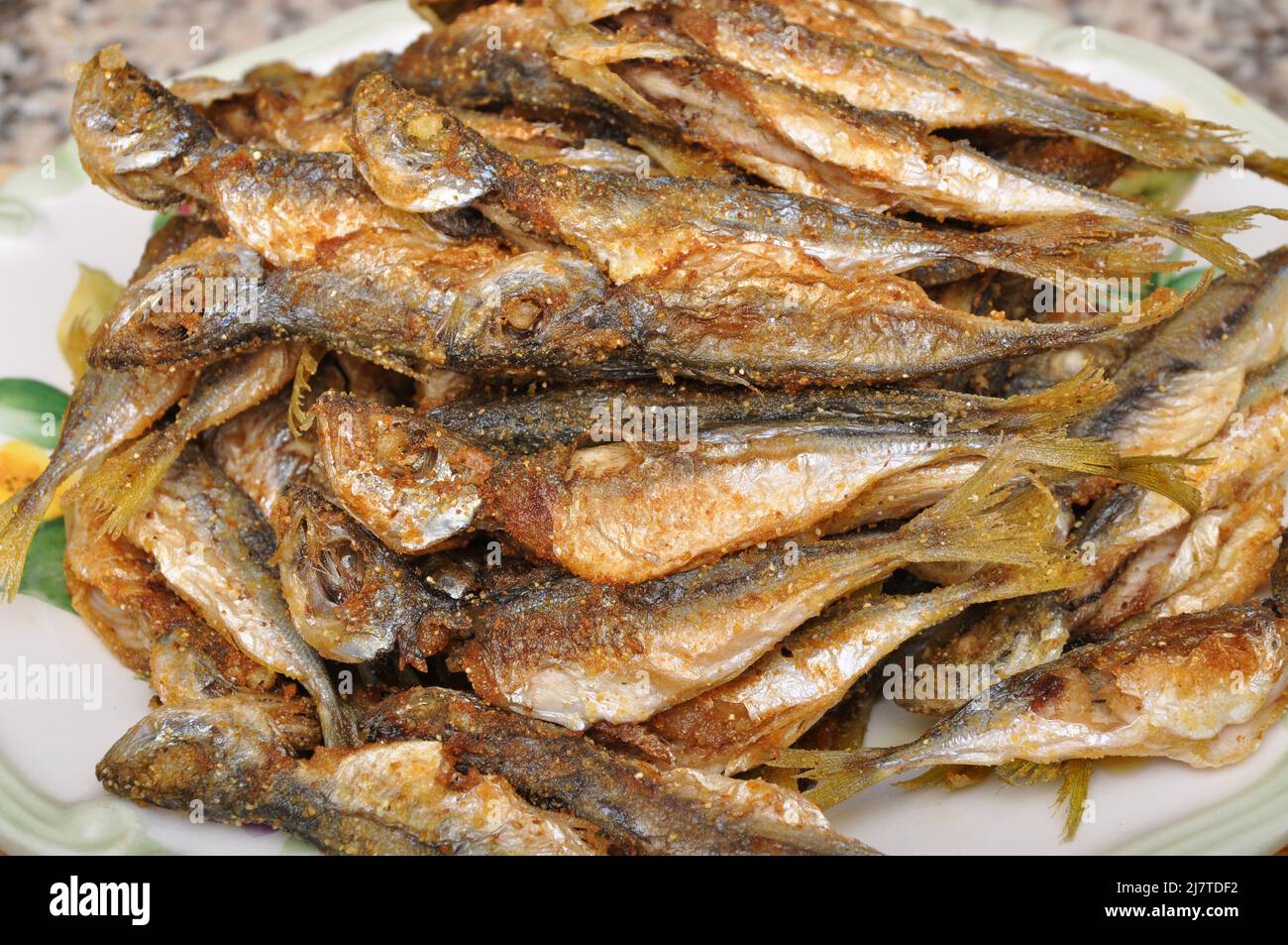 Delicious and beautiful fried horse mackerel istavrit fish, in a white ...