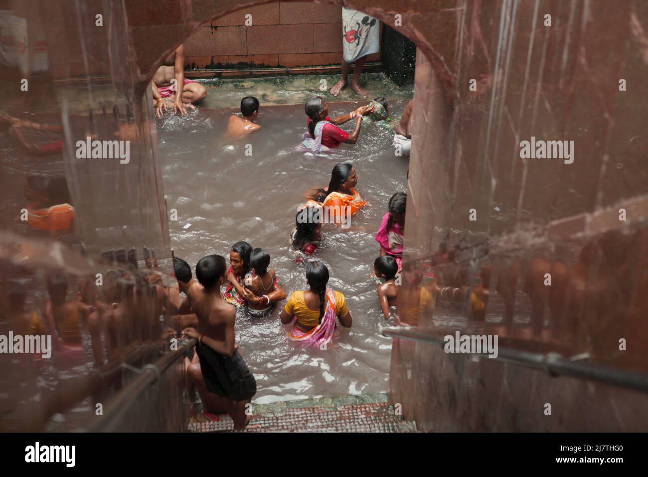 People taking a bath at a hot spring, which is believed to have ...