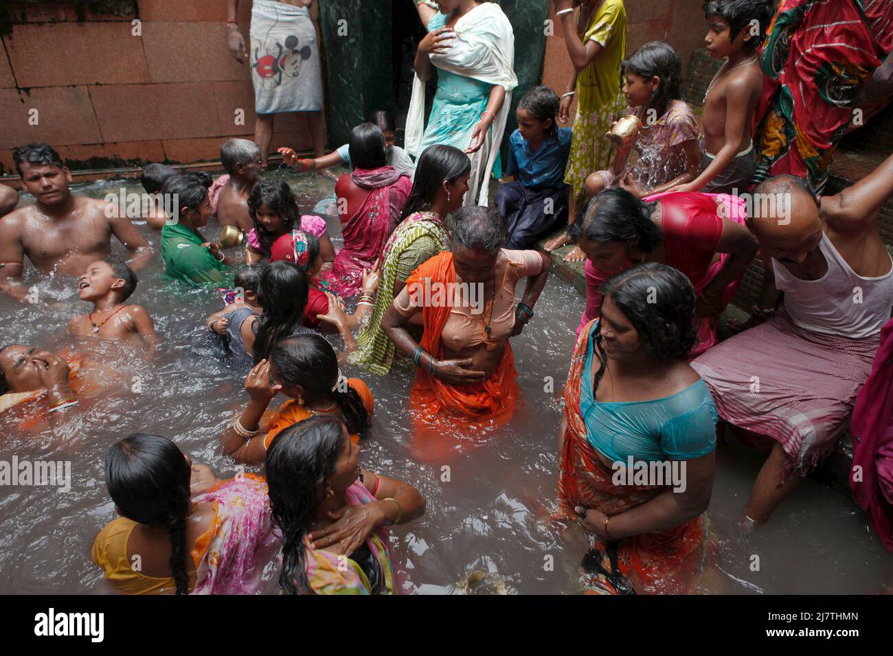 People taking a bath at a hot spring, which is believed to have ...