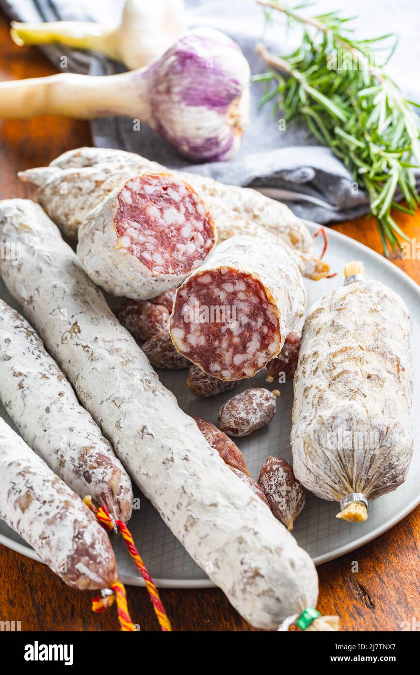 Traditional sausage with white mold. Dried pork salami on a plate Stock ...