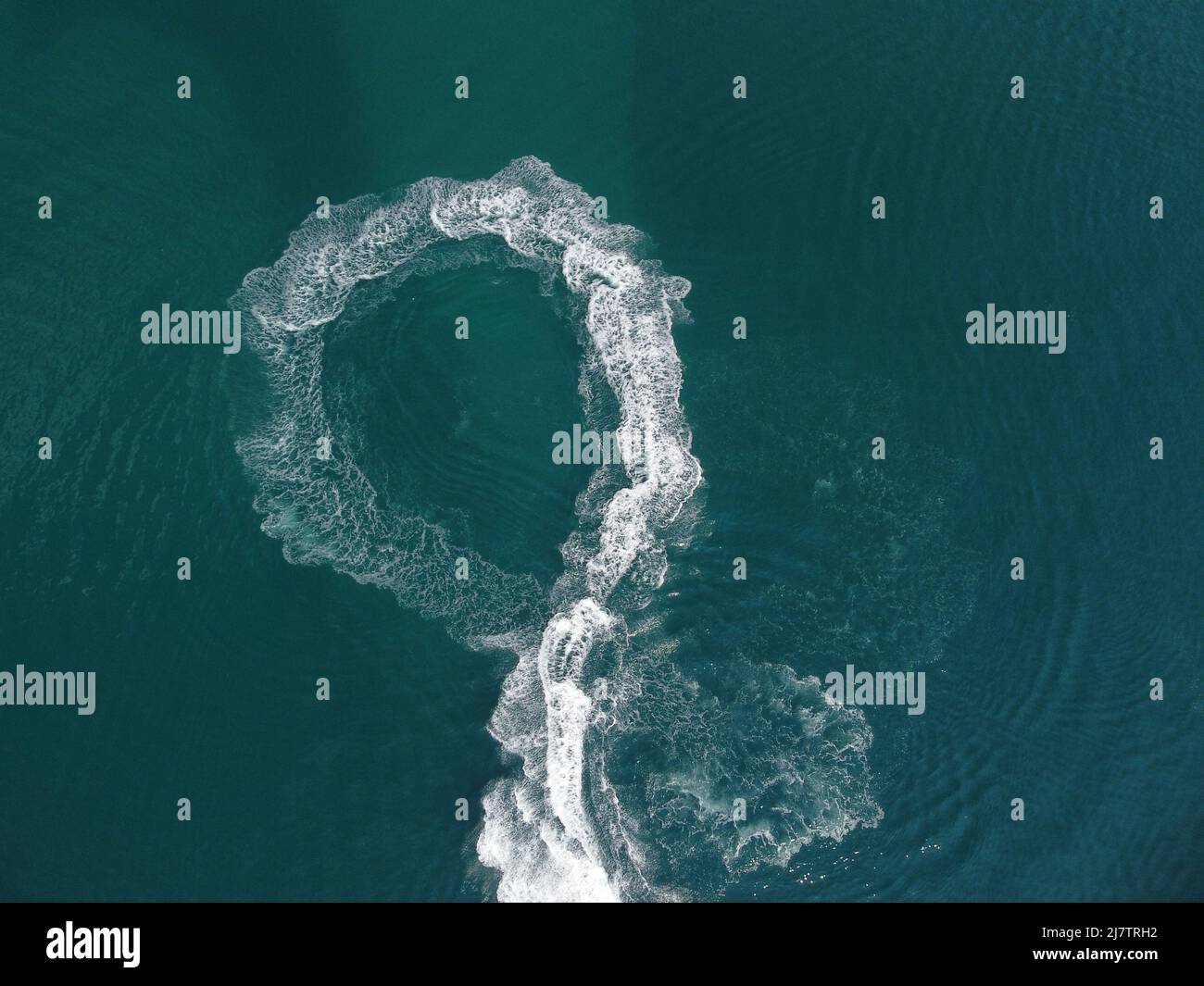 Aerial top down view of water foam trace with nice deep blue shade of ...