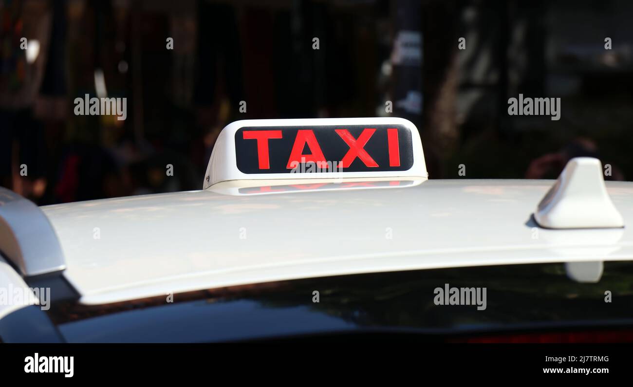 A red Taxi sign on a taxi in the city Stock Photo - Alamy