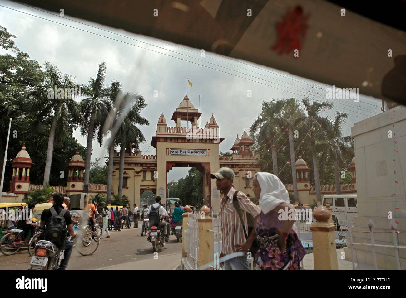 Road traffic in front of the gate of Banaras Hindu University complex ...