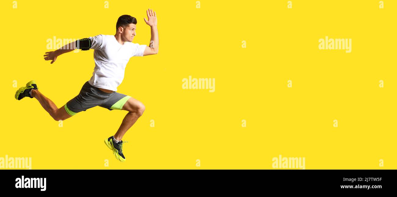 Sporty male runner on yellow background with space for text Stock Photo ...