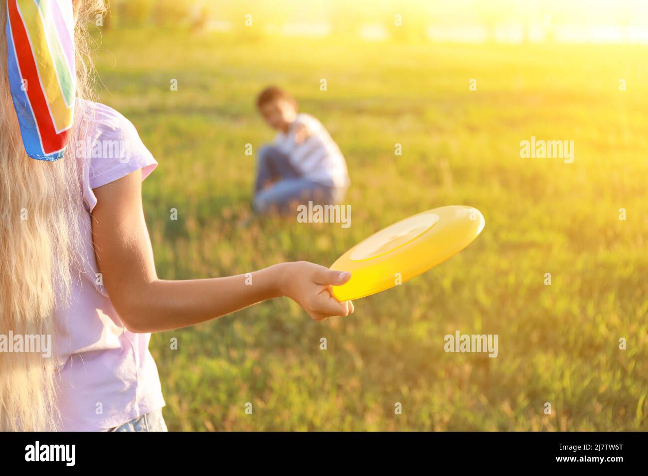 Funny little children playing frisbee outdoors on sunny day Stock Photo ...