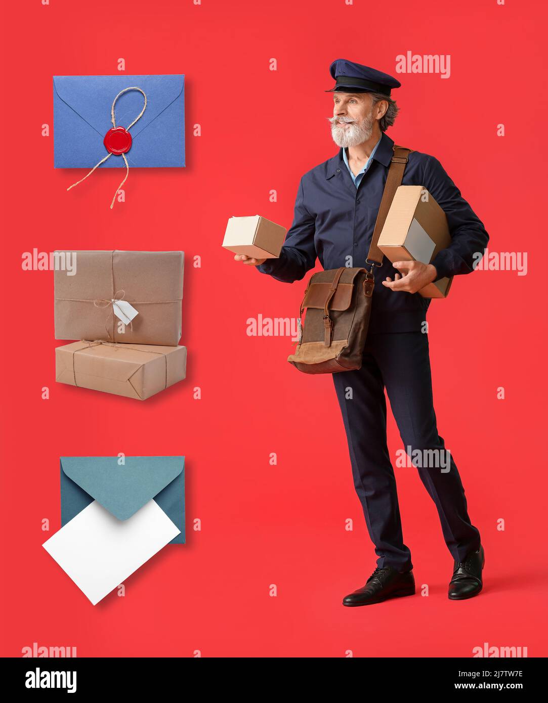 Handsome senior postman, envelopes and parcels on red background Stock ...