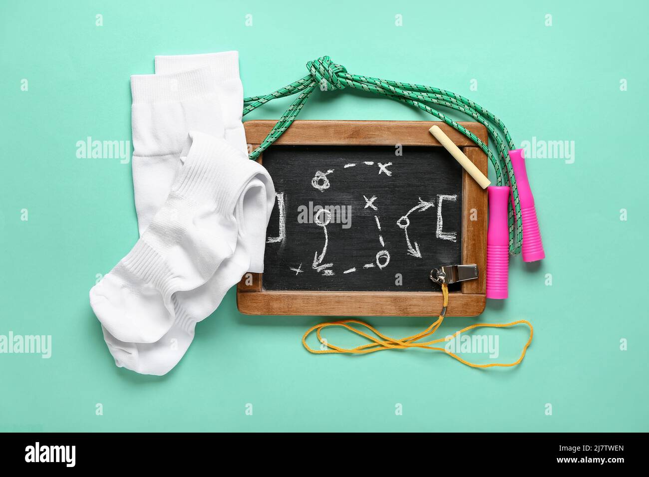 Chalkboard with drawn scheme of football game, socks, skipping rope and ...