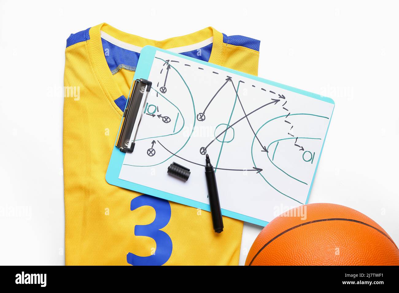 Clipboard with drawn scheme of basketball game and uniform on white ...