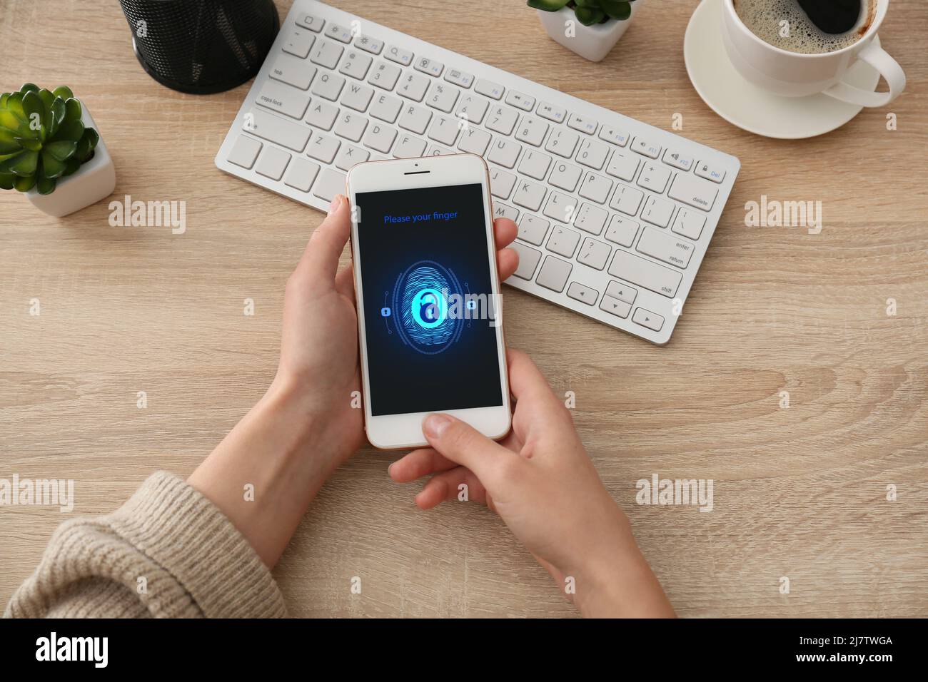 Woman holding smartphone with locked screen at table, top view Stock ...