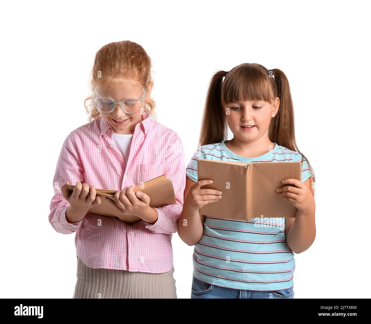 Little girls reading books on white background Stock Photo - Alamy