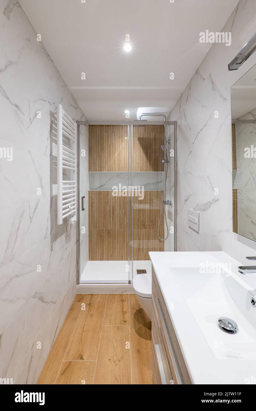 Shower zone with wooden finishing and glass door. Interior of modern ...