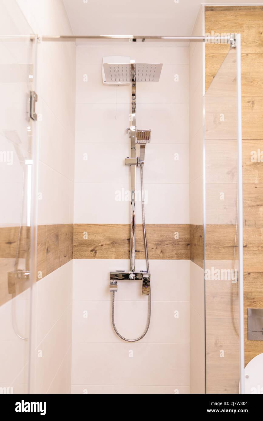 modern bright shower cabin close-up, with water equipment, vertical ...
