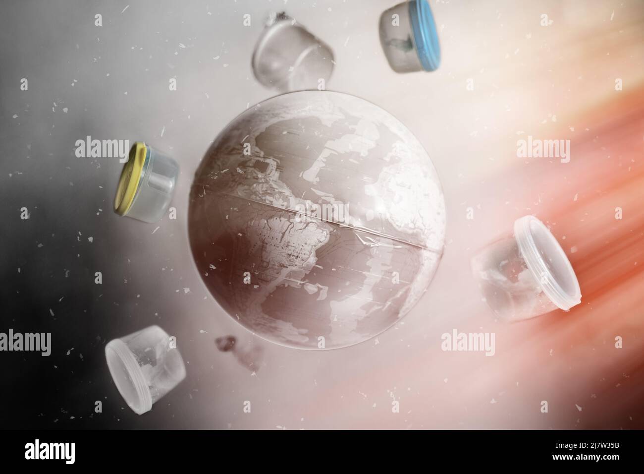 Globe of Planet earth surrounded by plastic bottles and garbage.The ...