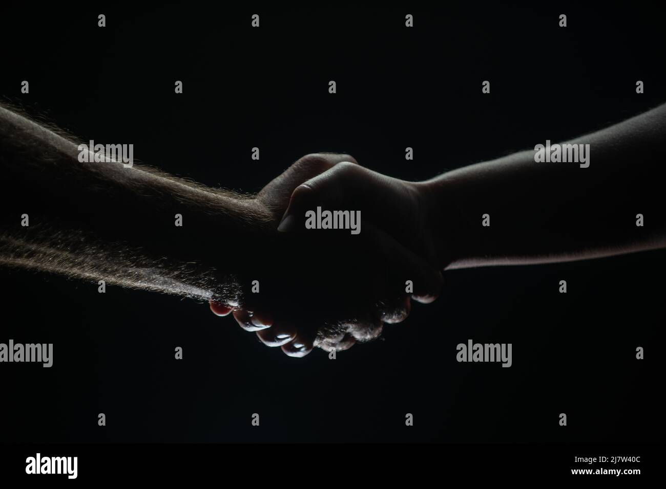 Handshake between the two partners, agreement. Male hands rescue ...