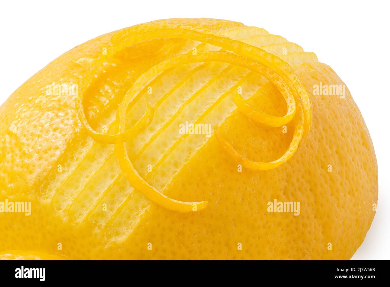 Detail of partially peeled half of lemon with strips of lemon zest on ...