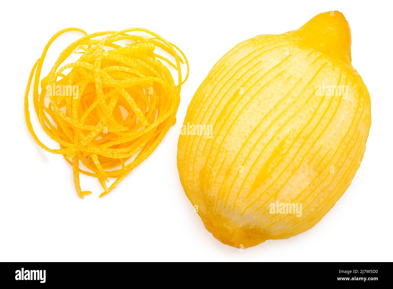 Half of peeled lemon next to heap of freshly peeled lemon zest isolated ...