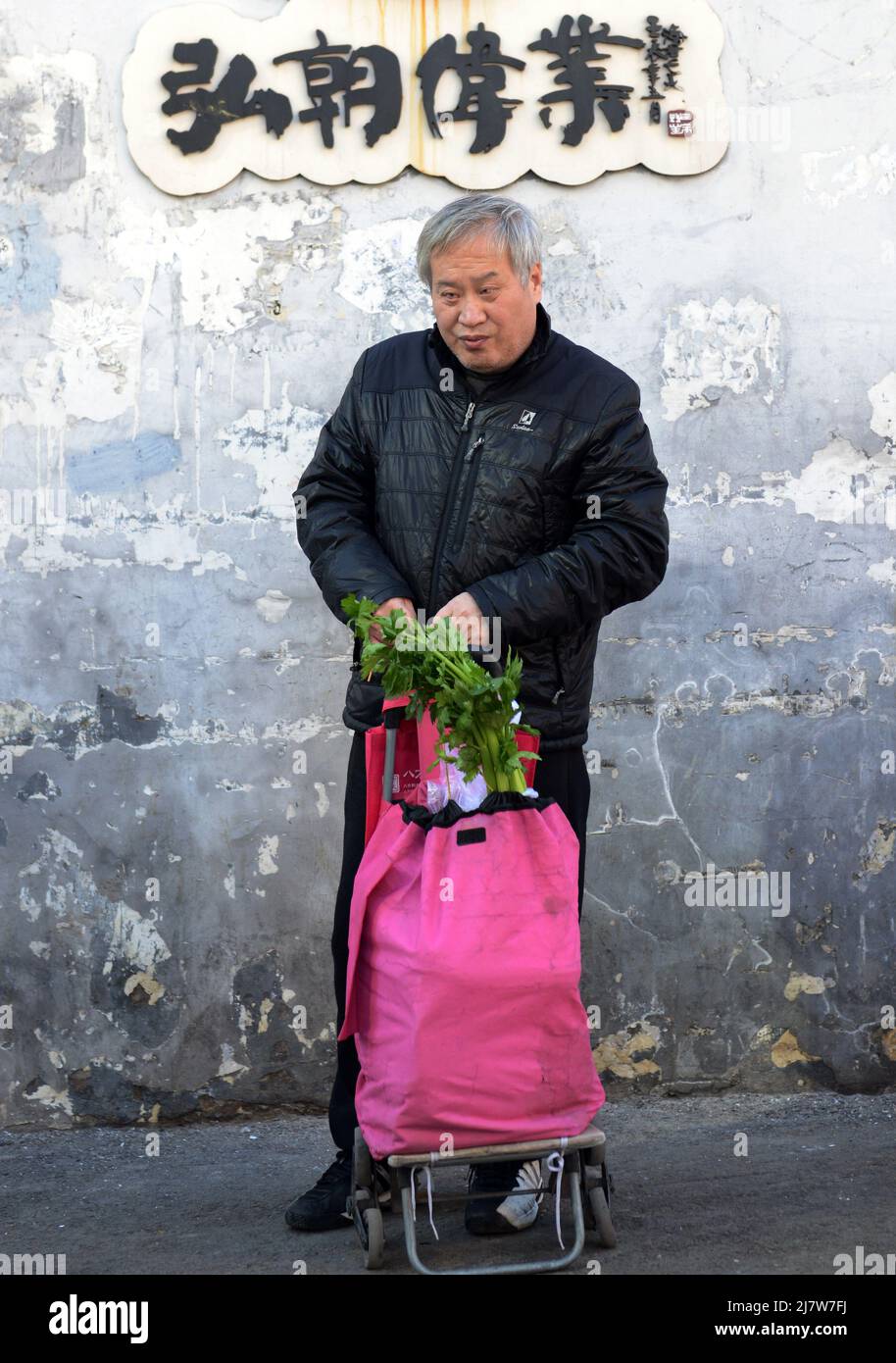 A Chinese man shopping in a local market in Beijing, China Stock Photo ...