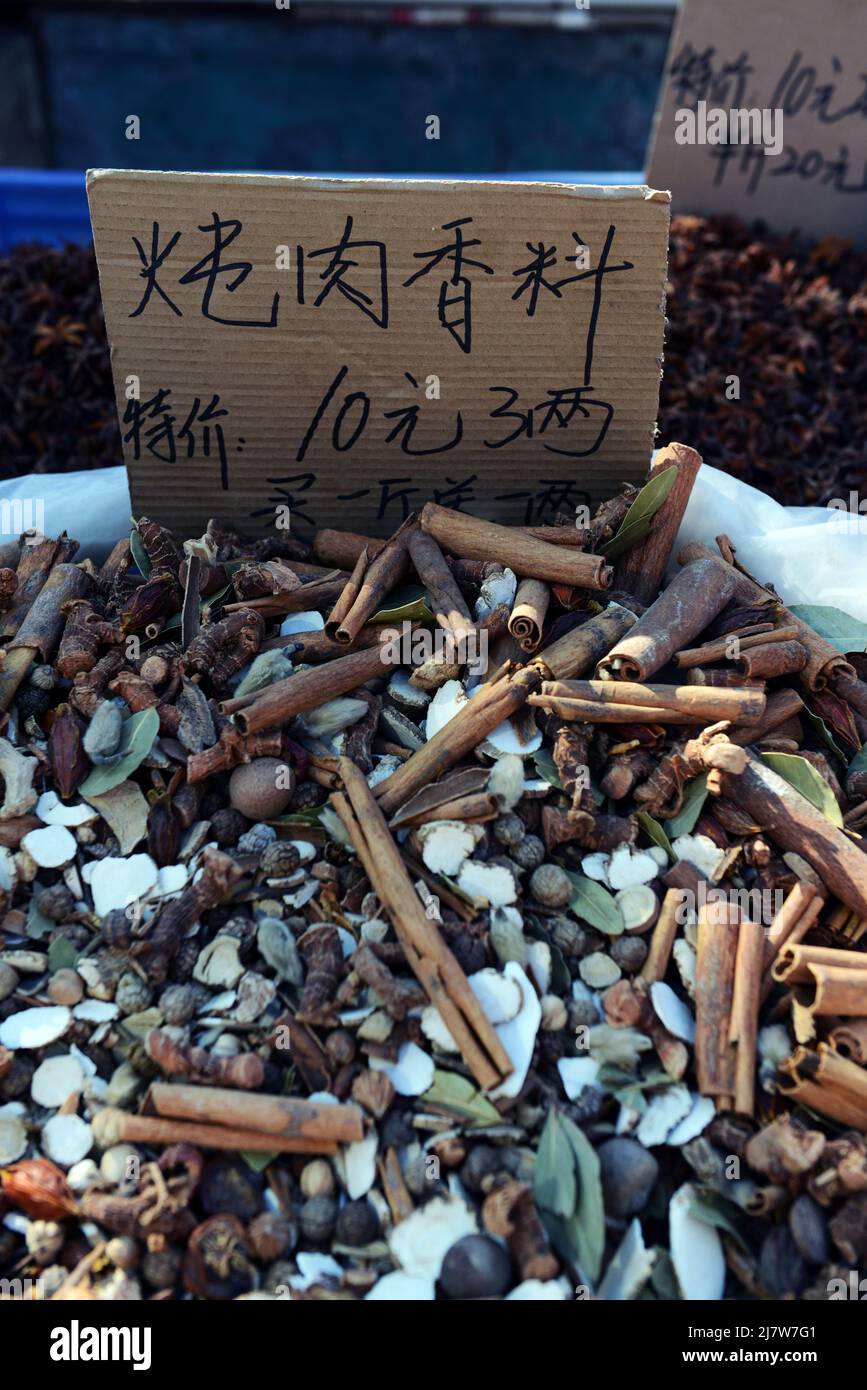 A mix of Chinese spices displayed by a vendor at the large colorful ...
