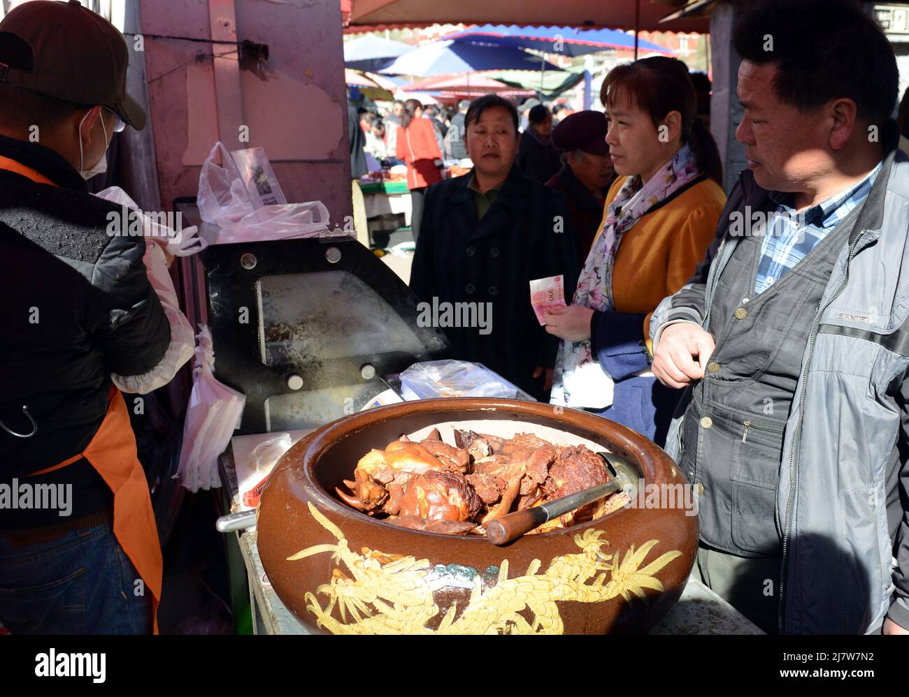 A pot of Chinese stew cooked in a traditional clay pot ( Sha Guo ) at a ...