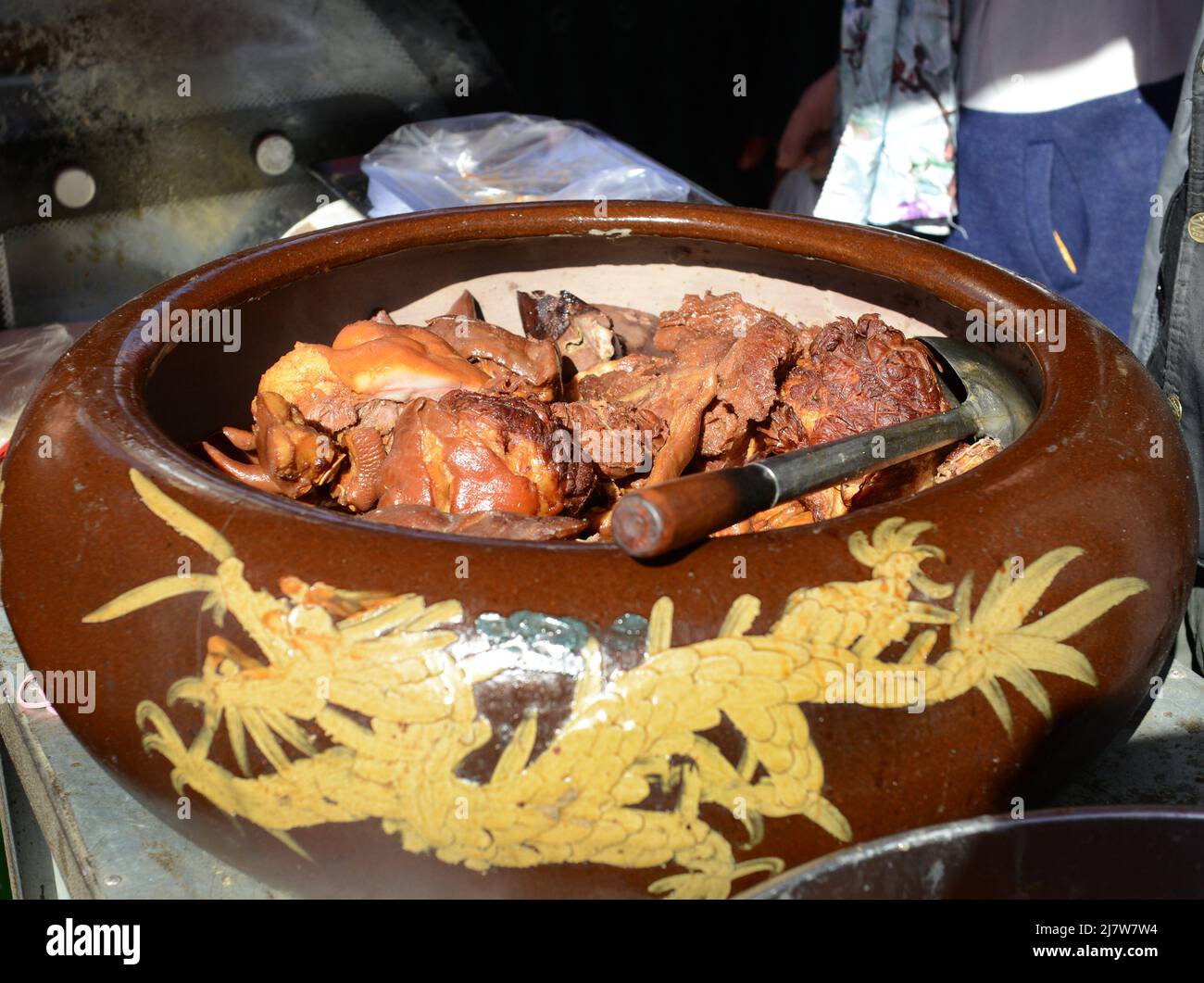A pot of Chinese stew cooked in a traditional clay pot ( Sha Guo ) at a food stall at the ...